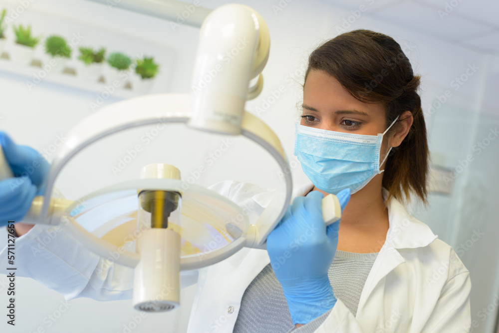 female dental worker setting up equipment Stock Photo | Adobe Stock