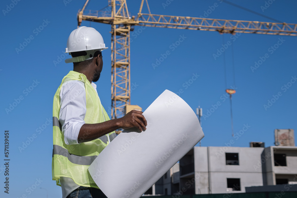 African American architect compares building construction to drawings ...