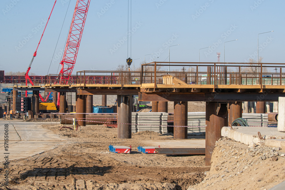 The mobile crane is loading the cargo. View of the construction site ...