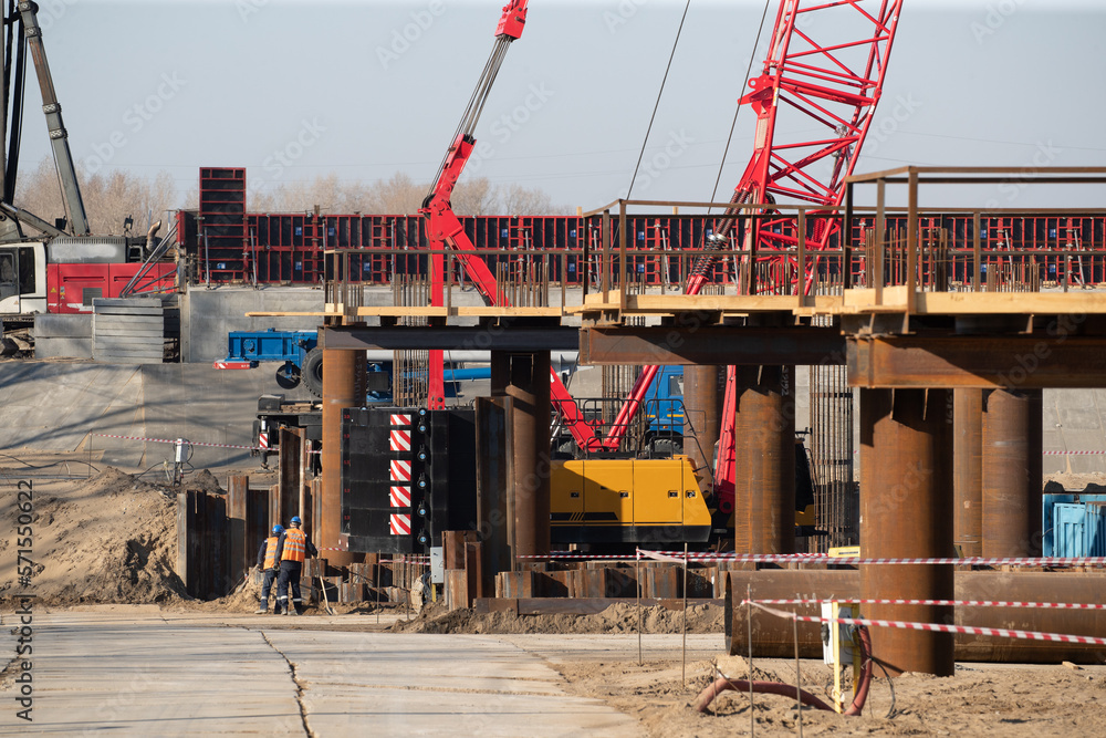 The mobile crane is loading the cargo. View of the construction site ...