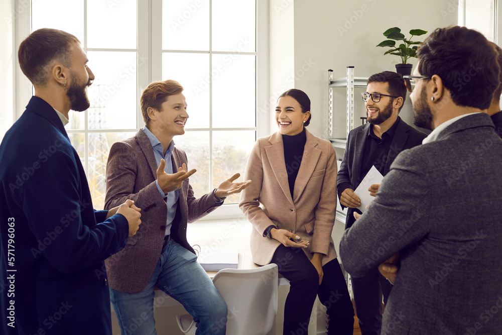 Group of a young happy smiling business people chatting after a meeting ...