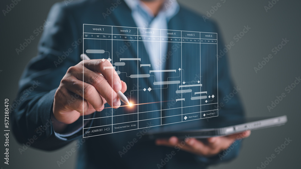 Project manager working with Gantt chart schedule to plan tasks and ...