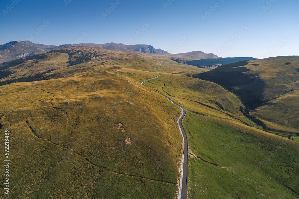 Aerial view of Bucegi Mountains and Transbucegi waving road on top of ...