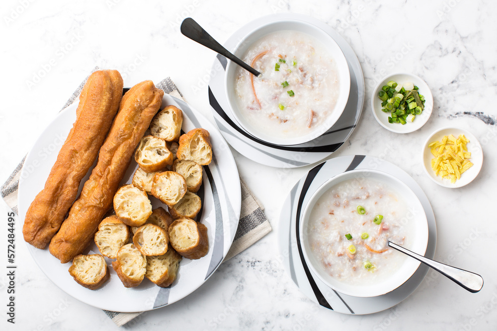 Beef Squid Pork congee with Youtiao, also known as Chinese fried dough ...