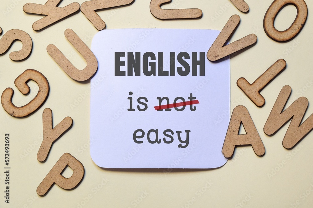 White card with the text English is easy and 3d wooden alphabet letters ...