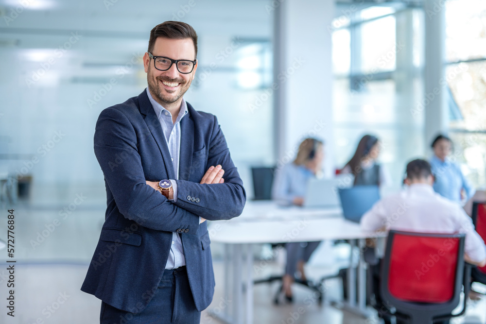 Handsome business CEO executive business man with crossed arms standing ...
