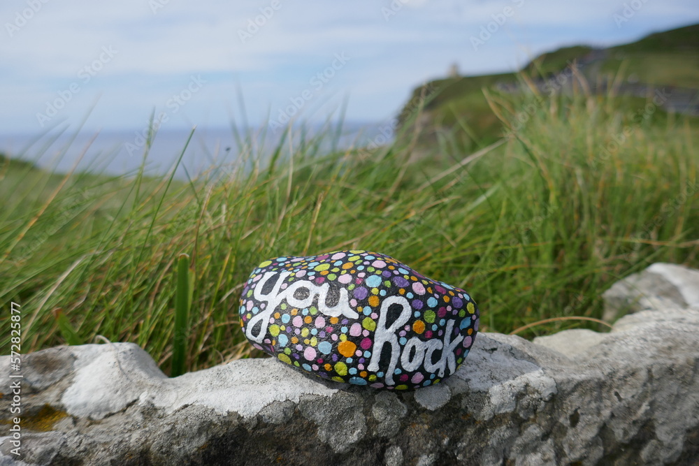 Ancient stone wall by cliff with painted rock and you rock message ...