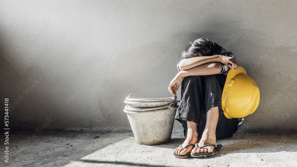 Exhausted little girl sitting on floor concrete wall background. child ...