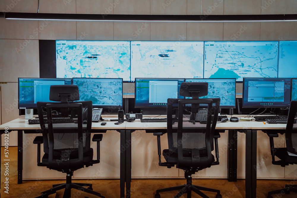 Empty interior of big modern security system control room, workstation ...