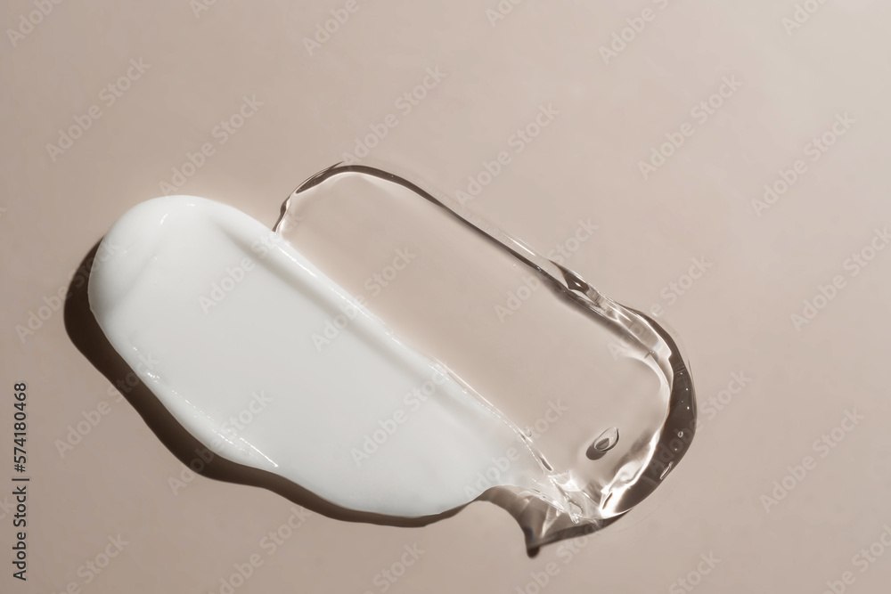 Liquid cream and gel cosmetic smudge drops texture on beige background ...