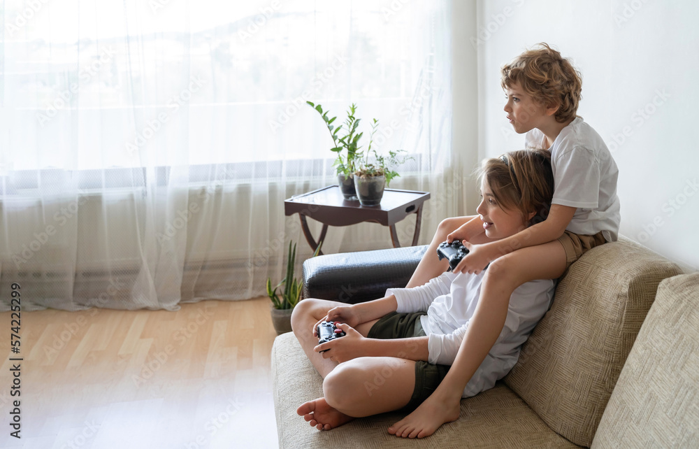 Gamer children joyful playing video games with controller console ...