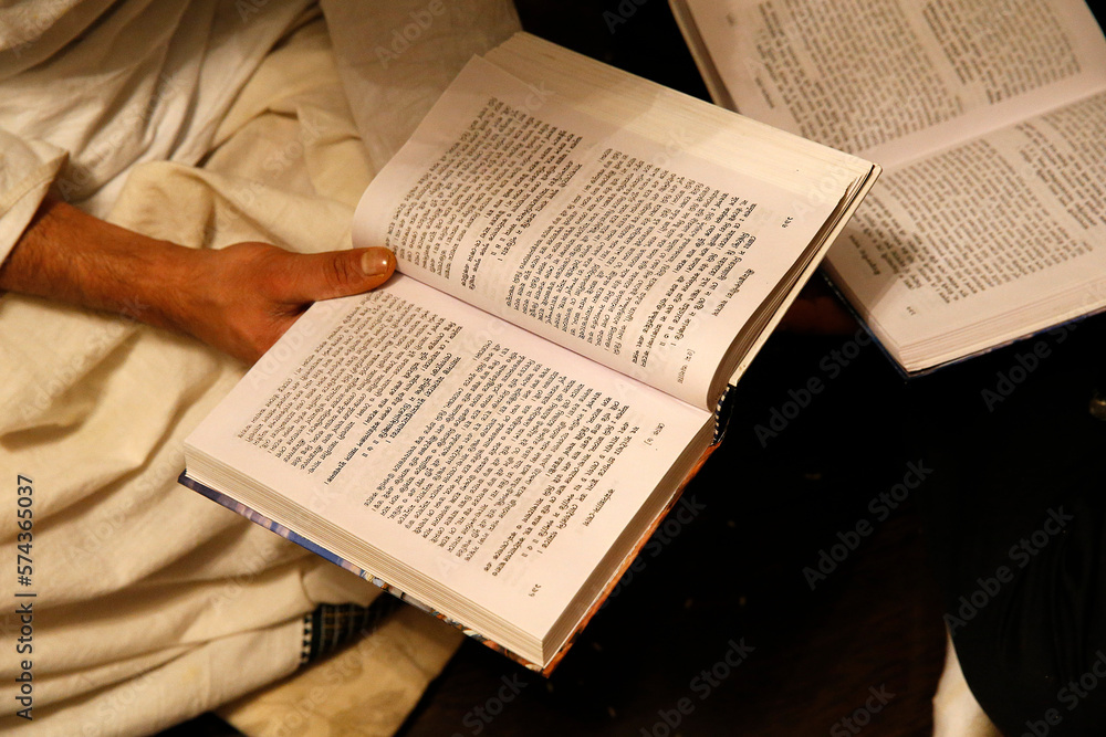 Gita Jayanti celebration in an ISKCON temple. Devotees reading the ...