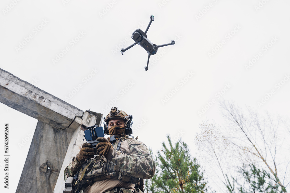 Military soldier controls drone for reconnaissance operation of enemy ...