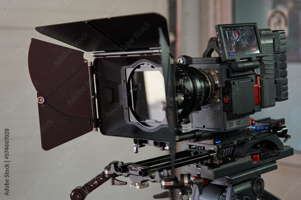 professional movie camera in full equipment. camera cube, professional ...
