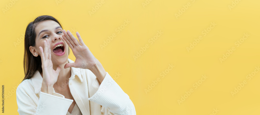 Cheerful caucasian young woman shouting - yelling with hands close up ...