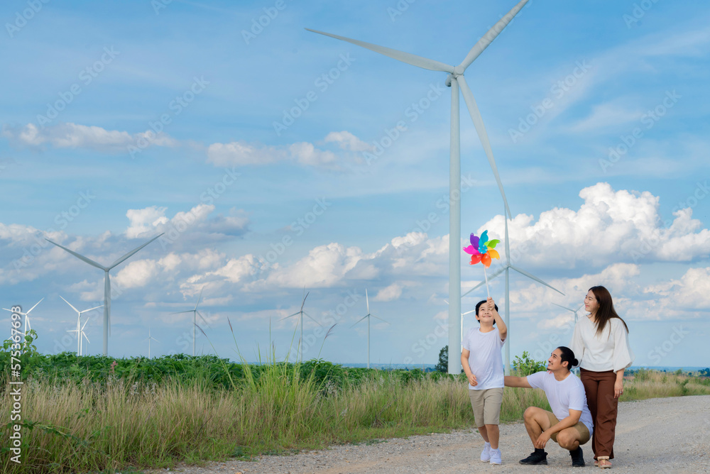 Progressive happy family enjoying their time at wind farm for green ...