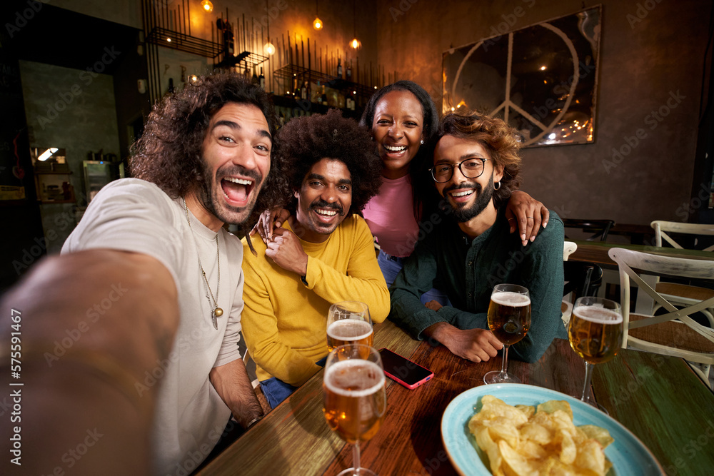 Portrait multiracial friends group looking camera at restaurant bar ...