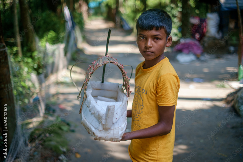 Village kids of Bangladesh making raft by sticks and cork sheet , hobby ...