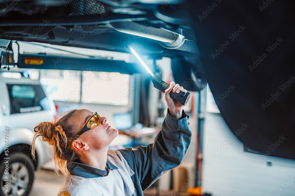 Mechanic working on a vehicle in a car service. inspection of the car ...