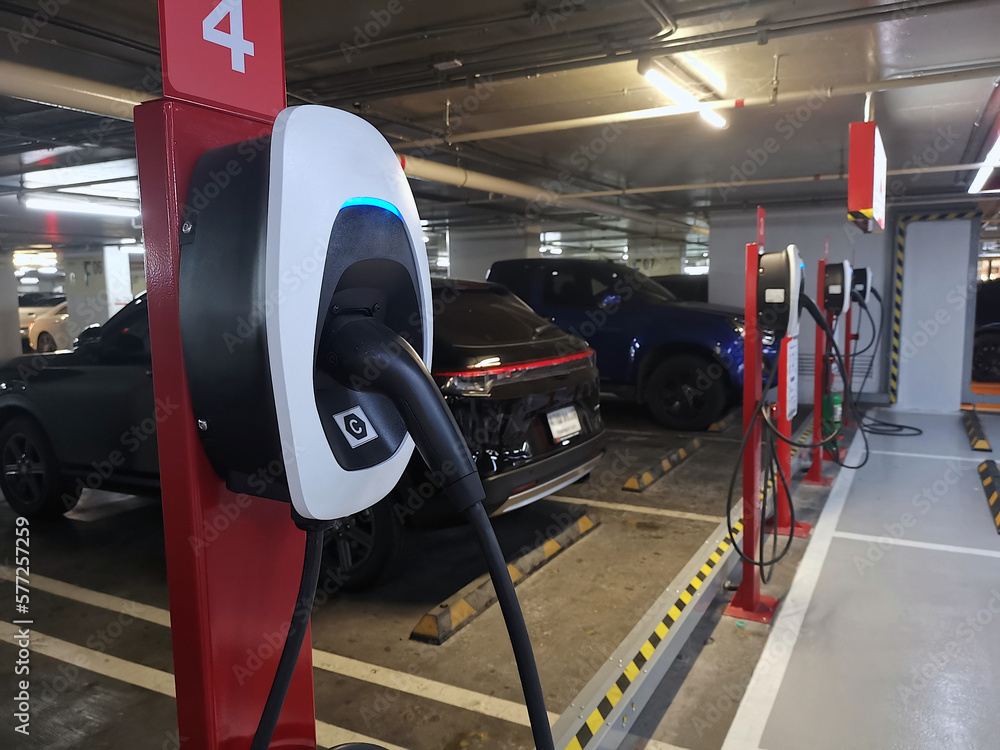 Indoor parking lot with electric vehicle charging stations available ...