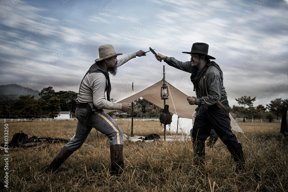 photographer in action. two cowboy fighting on the grass. vintage ...