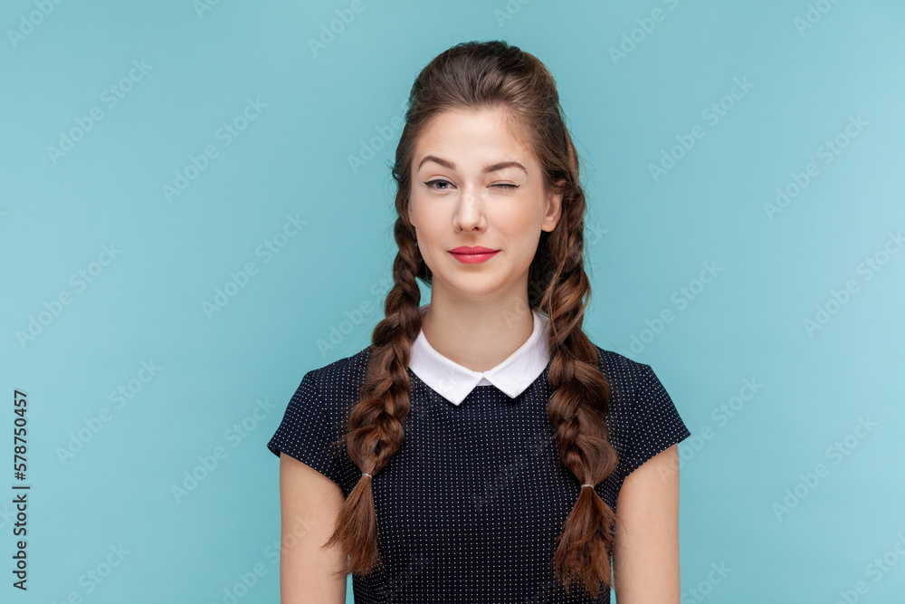 Coquettish happy positive woman standing and looking winking to camera ...