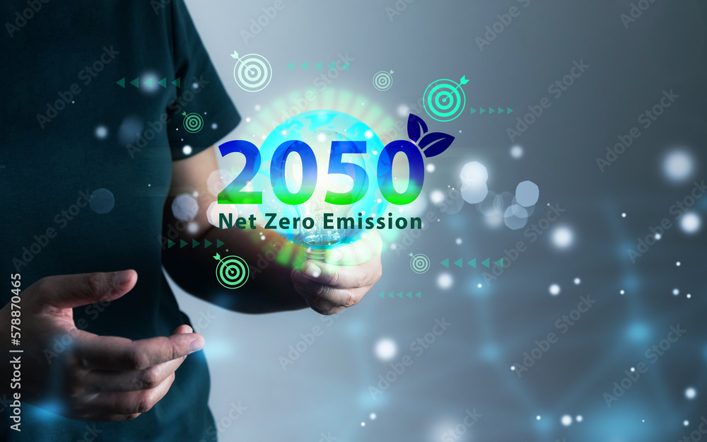 Person hand holding light bulb with net zero emission 2050 concept ...