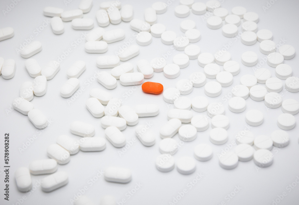 White circle medicine on white background, centered orange pill one ...