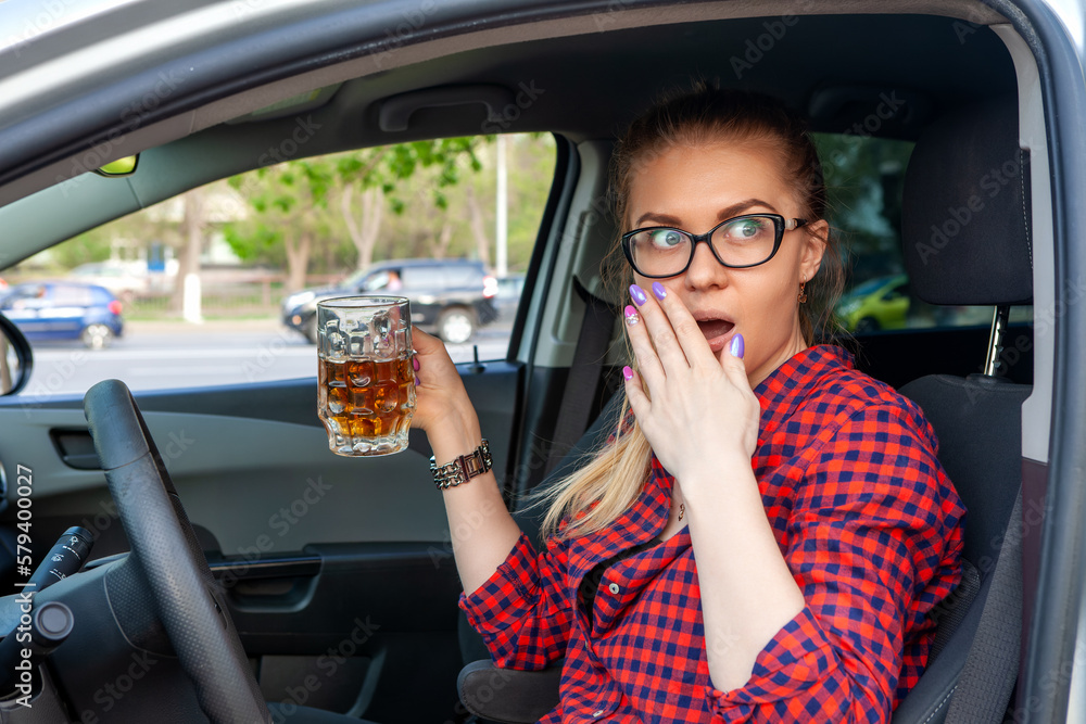 Drunk woman drives a car. The woman was caught drinking alcohol while ...