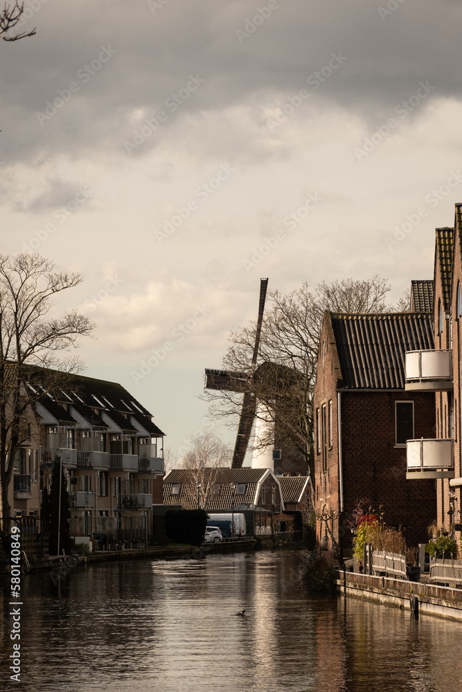 windmill and street houses in the Dutch city centre of Bodegraven ...
