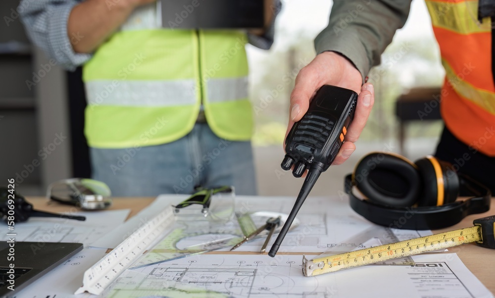 male engineer holding walkie talkie and civil engineer with working ...
