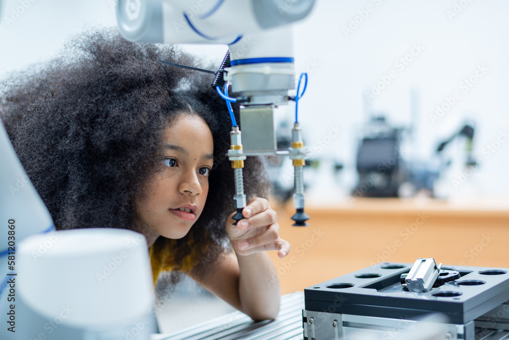Kid female teen child enjoy Machine Learning Robot arm is Moving Under ...
