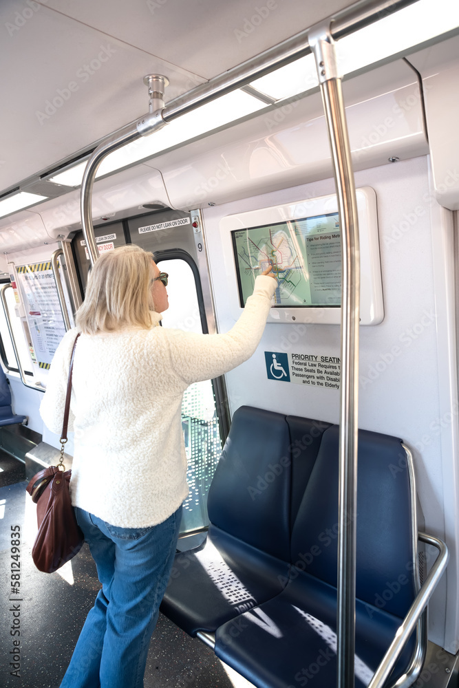 blonde woman on the DC subway is looking at a subway map. A new metro ...