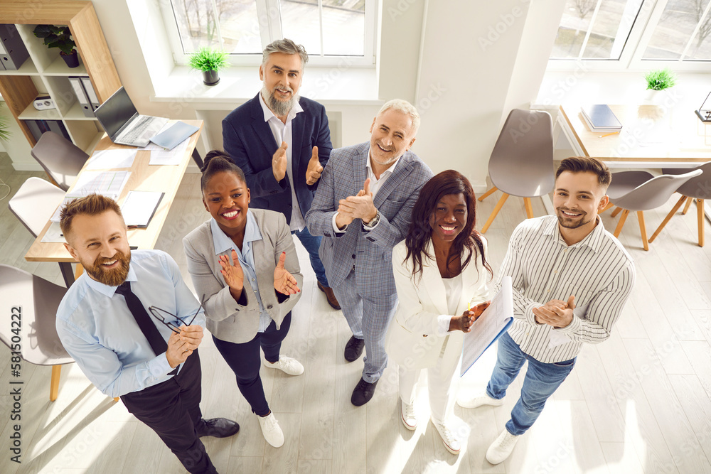 Happy diverse mixed race business team celebrating success at work ...