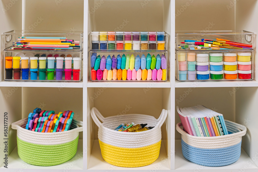 White shelving with various material for creativity and kids art ...