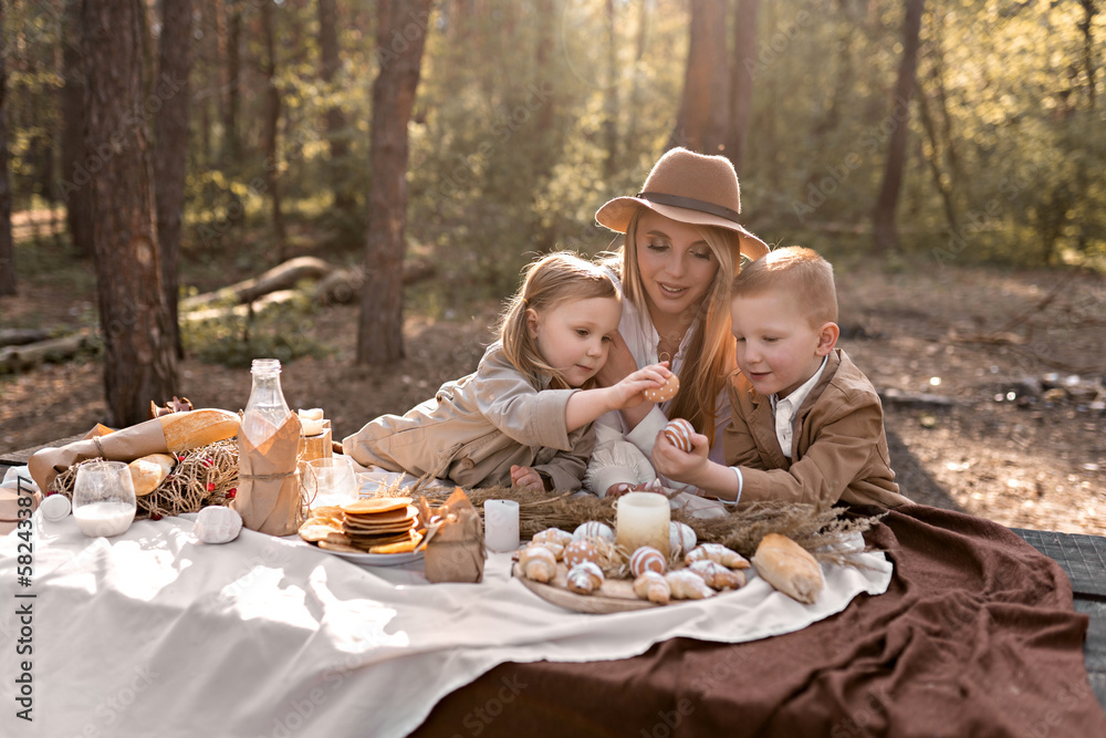 Photo Stock family with children is enjoying Easter picnic in spring ...