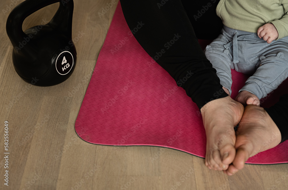 Baby and woman sitting on yoga mat ready for postpartum exercise with ...
