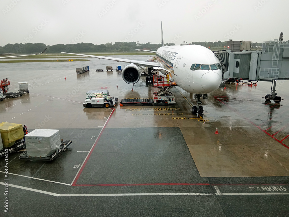 Hong Kong - March 1, 2023: Airplane at boarding gate jet bridge in Hong ... Hong Kong - March 1, 2023: Airplane at boarding gate jet bridge in Hong ...