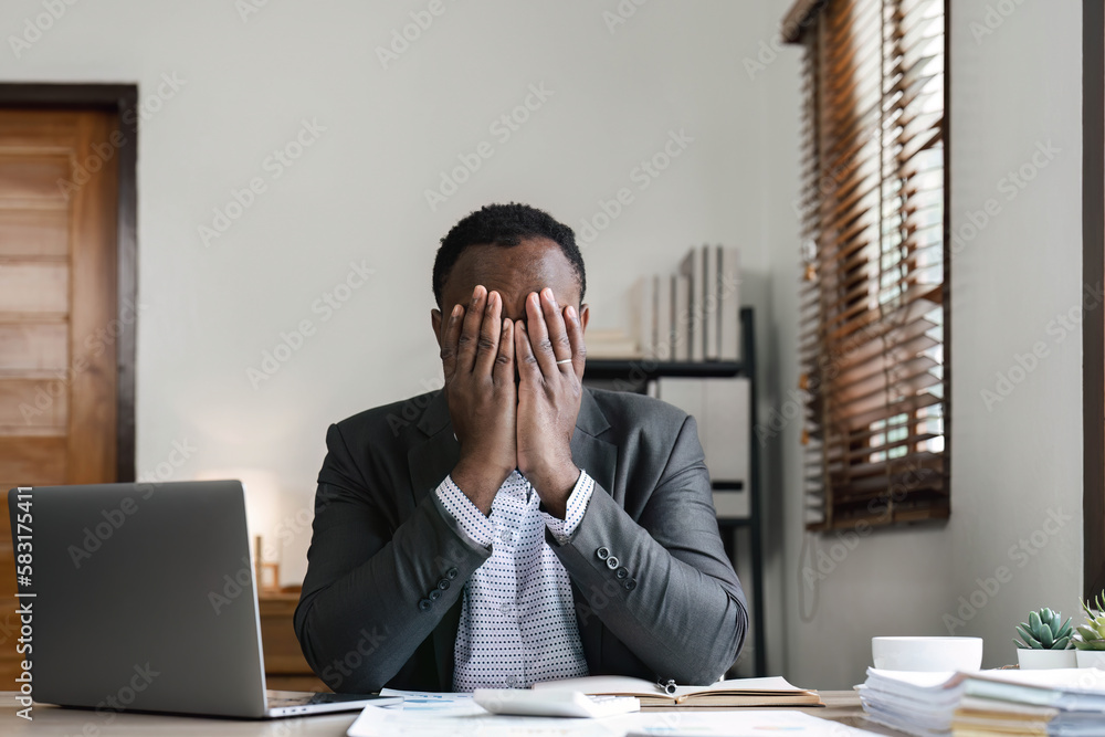 Stressed business man sitting at office workplace. Tired and overworked ...