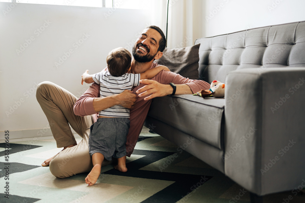 Happy father hugging little son at home. Happy Brazilian father embracing son Stock Photo ...