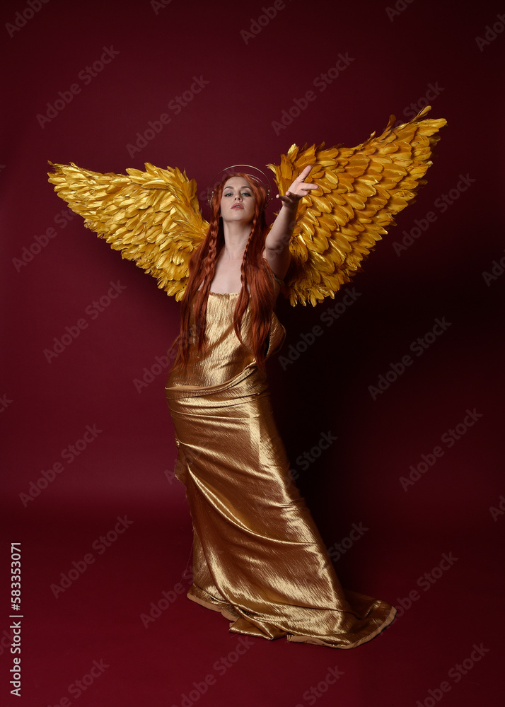 Full length portrait of beautiful woman model with long red hair, gold ...