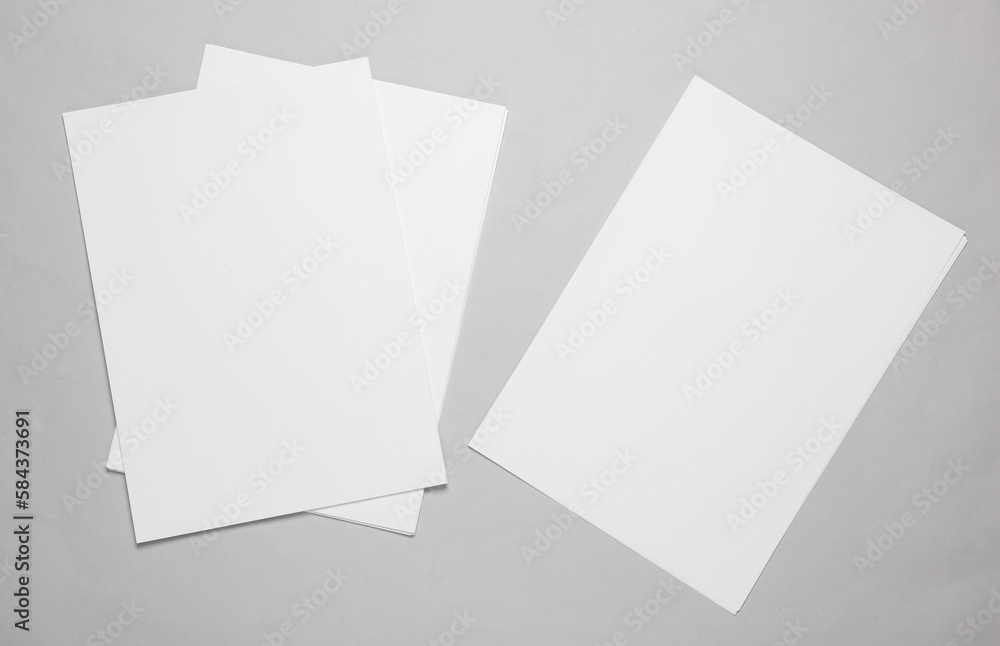 White blank sheets of a4 paper size or documents mockup on a gray ...
