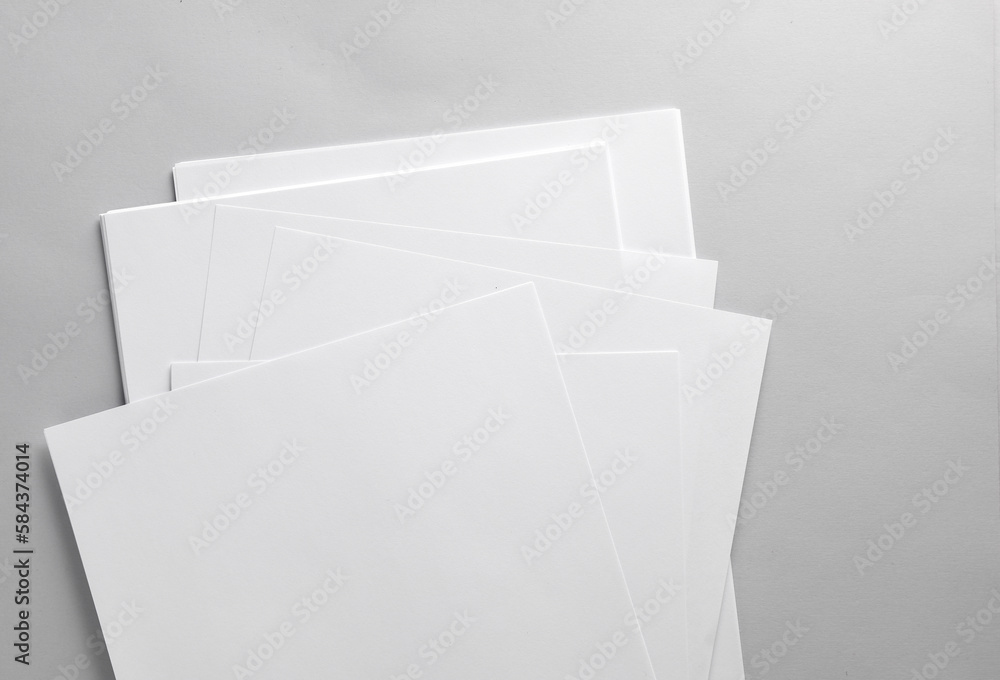 White blank sheets of a4 paper size or documents mockup on gray ...