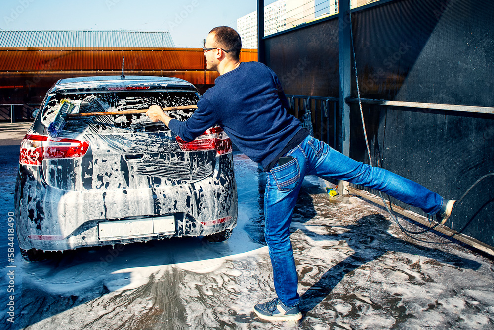 funny man washes a car at a car wash Stock Photo | Adobe Stock
