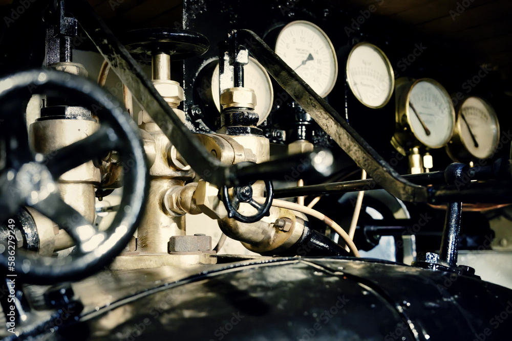The control room of a vintage steam train, a dashboard with many analog ...