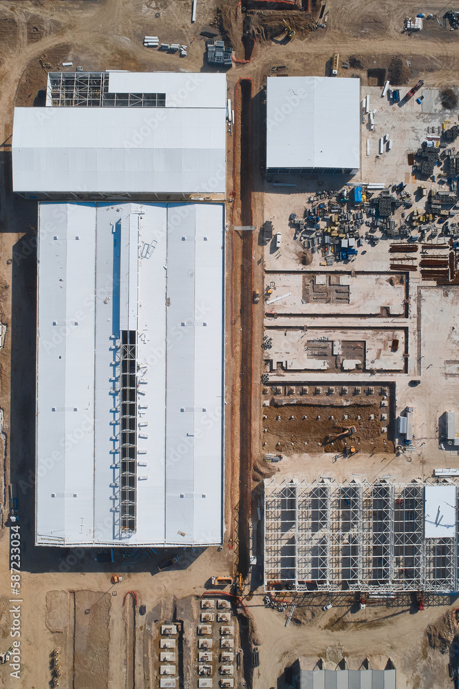 Prefabricated industrial buildings at construction site. Concrete ...