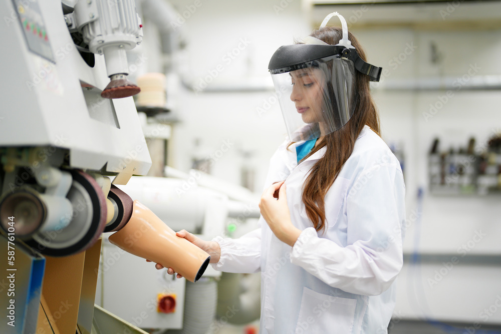 Production of a prosthetic leg. A man creates a part of the leg above ...