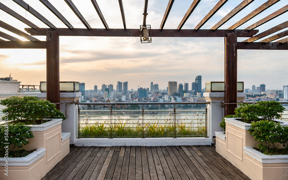 Rooftop view of Phnom Penh city skyline at sunset,looking across Tonle ...