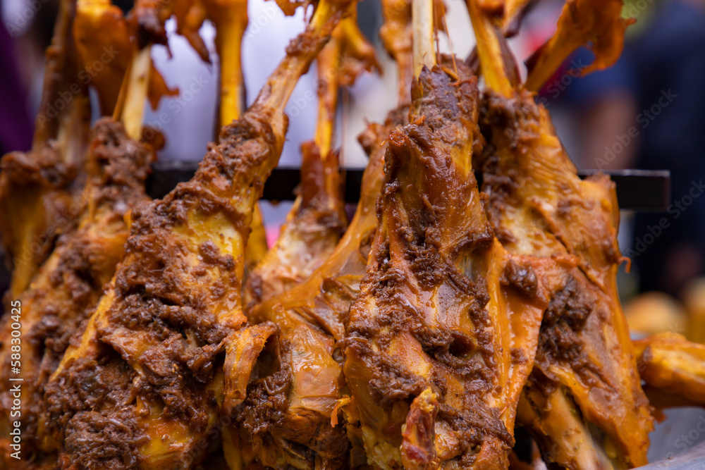 Roasted leg pieces of mutton at a street food market in Dhaka ...
