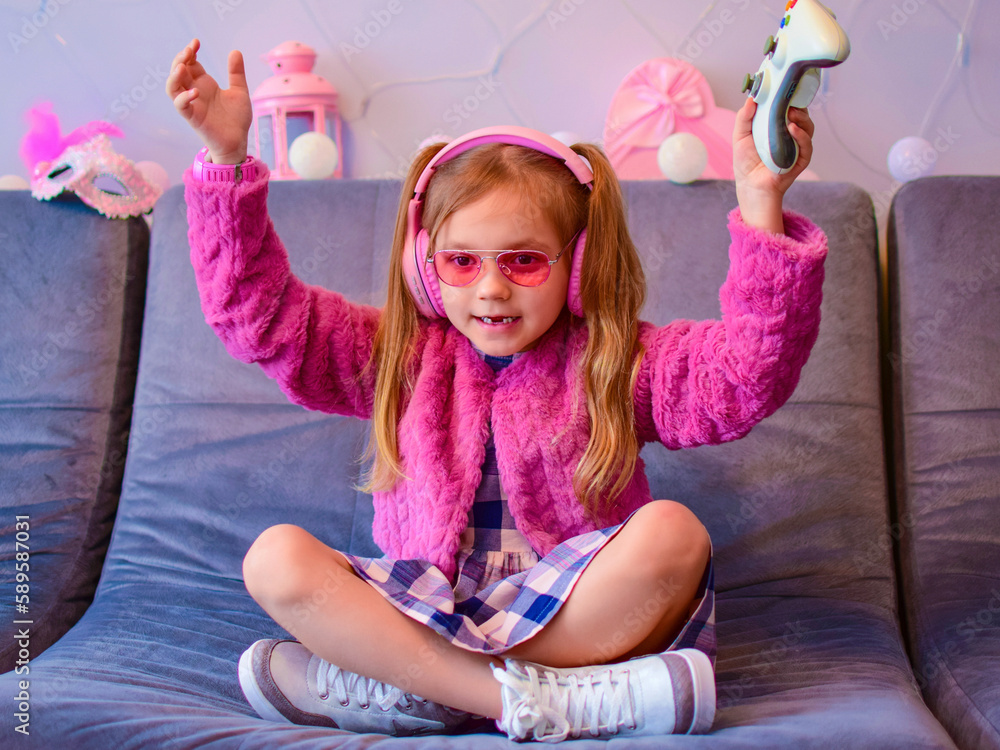 Child gamer. The unique child plays video games expressively. A ...